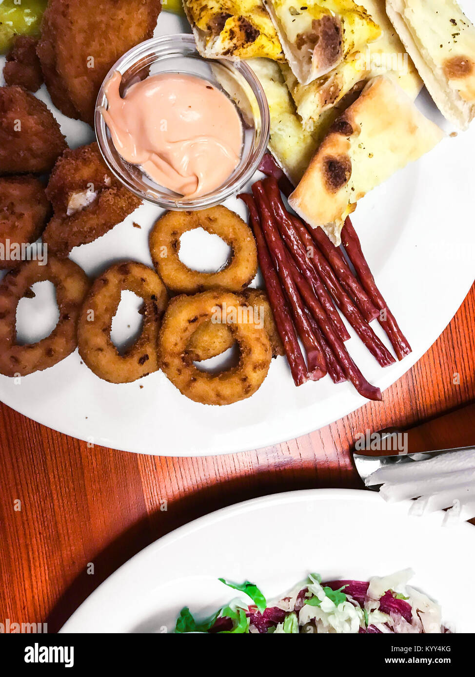 Plates with snacks on wooden table. Studio Photo Stock Photo - Alamy