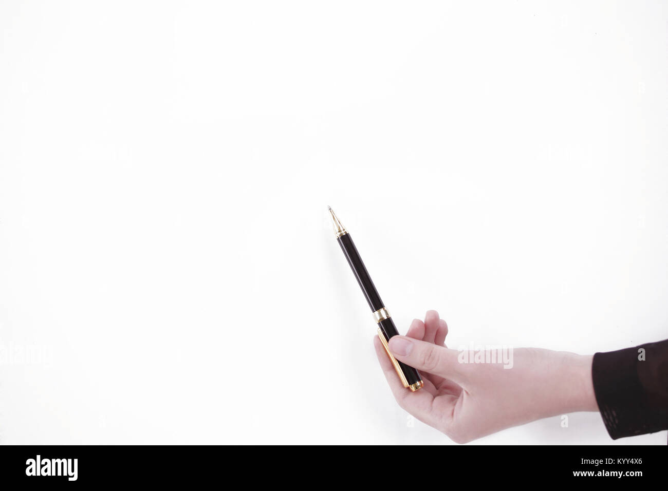 hand of business woman pointing with pen at a point on the blank screen ...