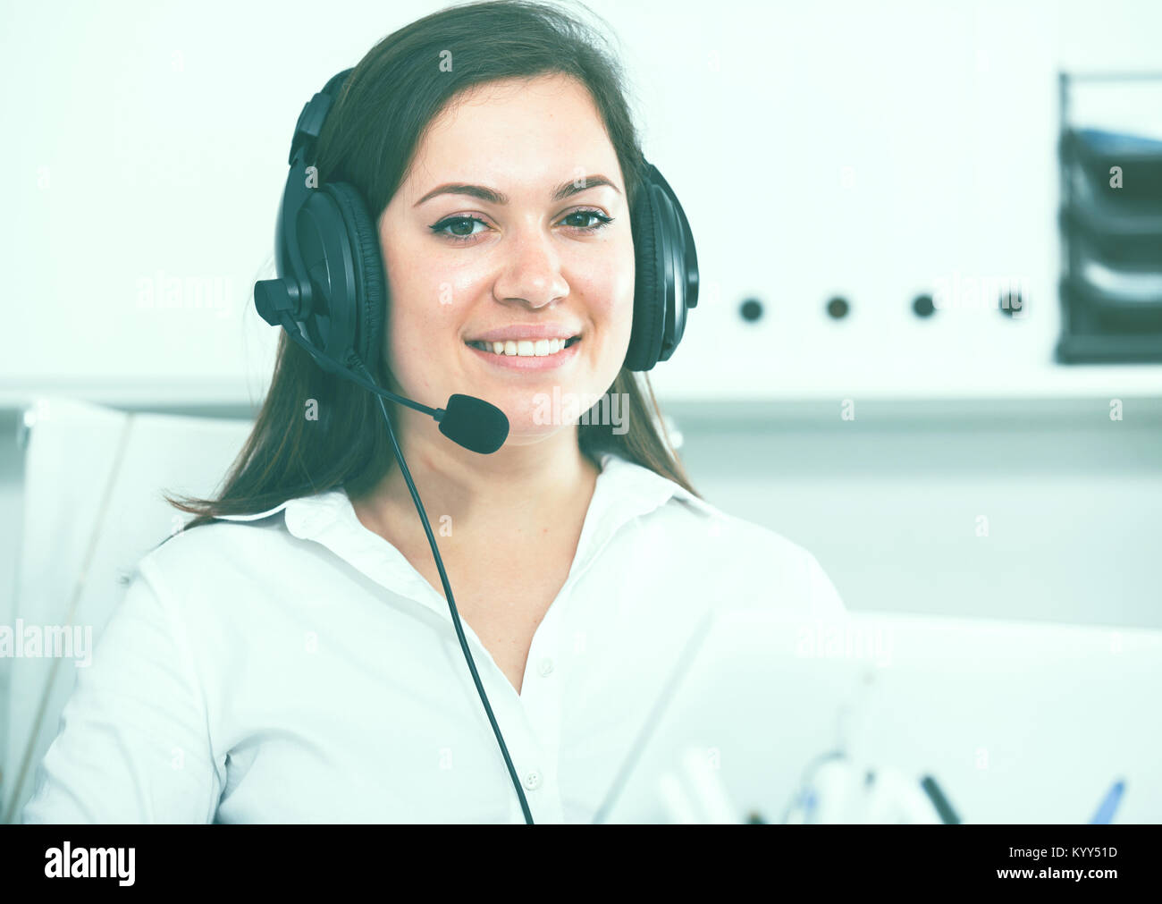Young female worker productively operating at call-center Stock Photo ...