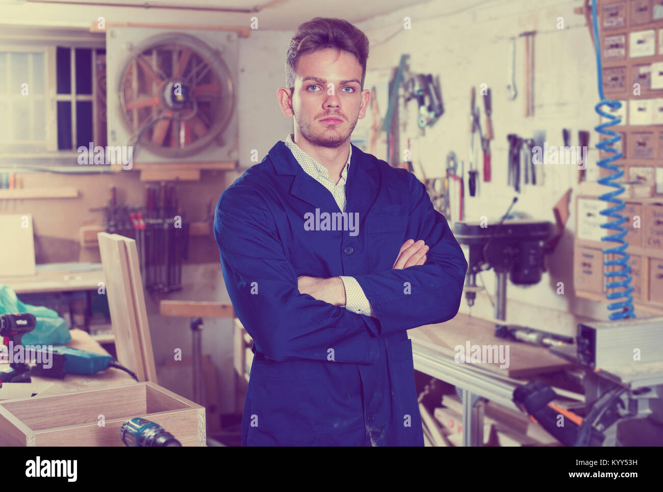 Young male joiner standing at his workplace with instruments Stock ...