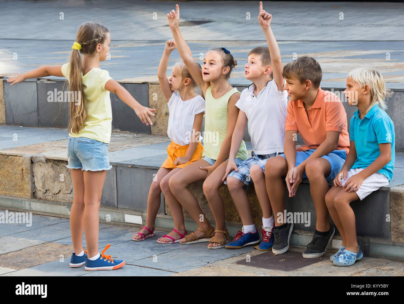 portrait of smiling spanish children spending time outside and playing ...