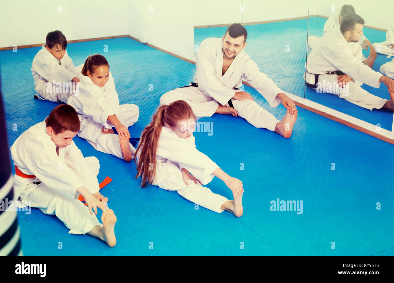 Young teenagers preparing physically to karate class Stock Photo - Alamy