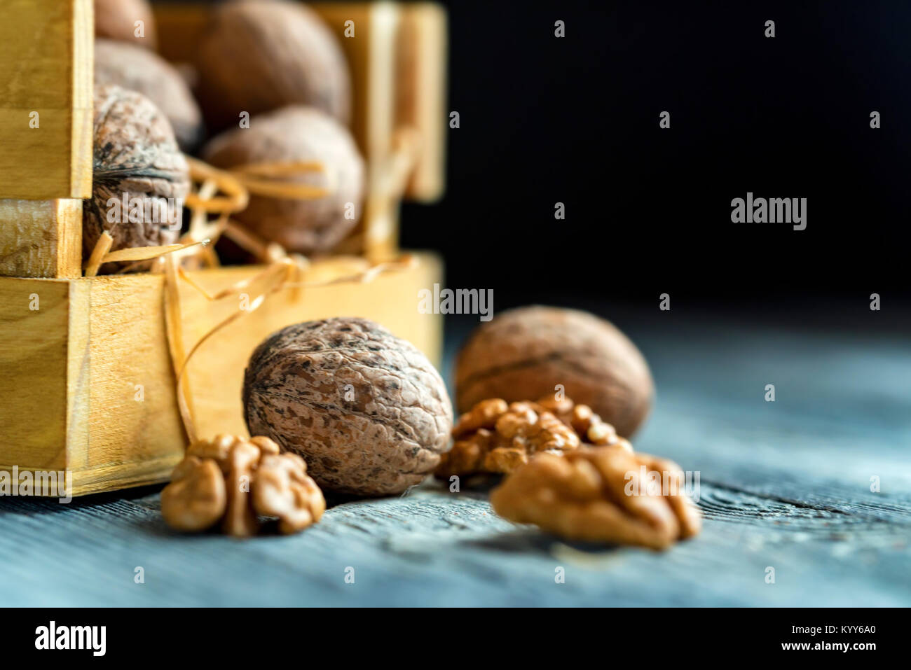 Walnuts in box on wooden backgound Stock Photo - Alamy