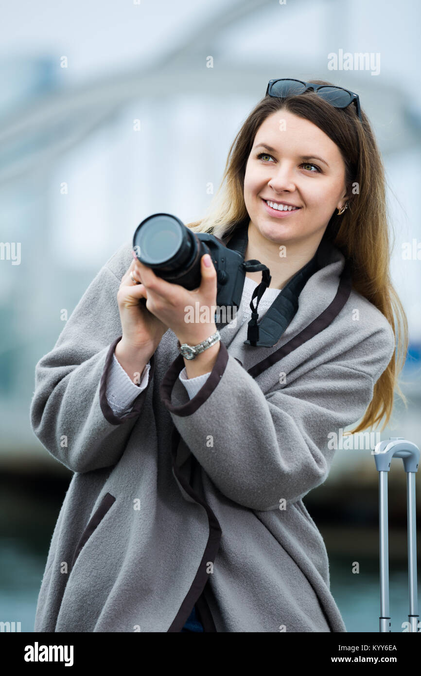 Young girl taking picture with her camera in the town Stock Photo - Alamy
