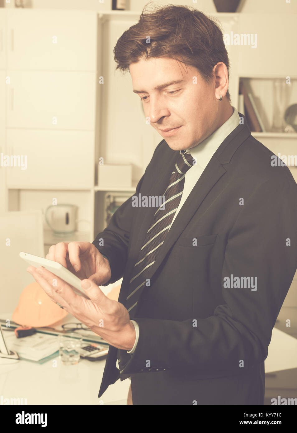 Young man working and touching screen in the office Stock Photo - Alamy