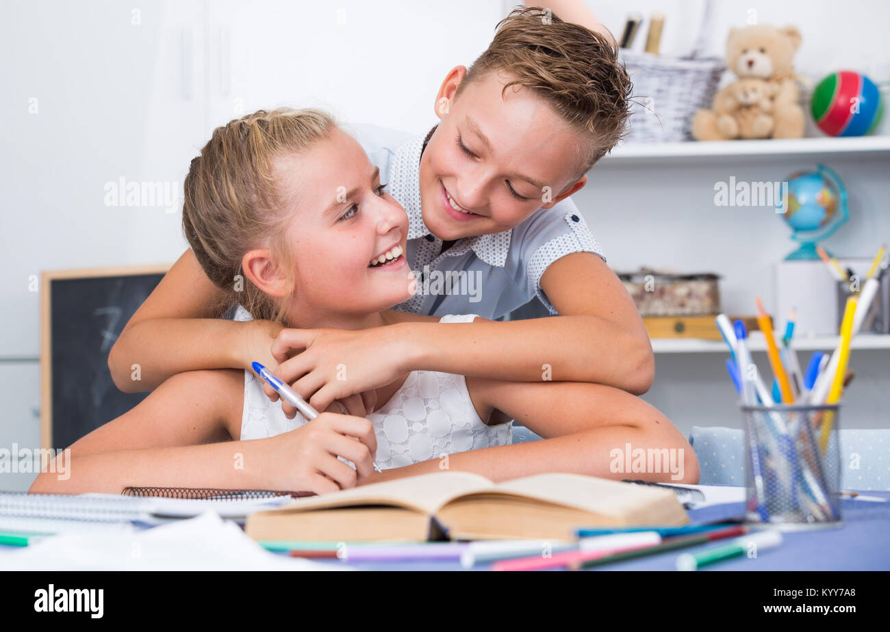 Brother is helping sister with homework at home Stock Photo - Alamy