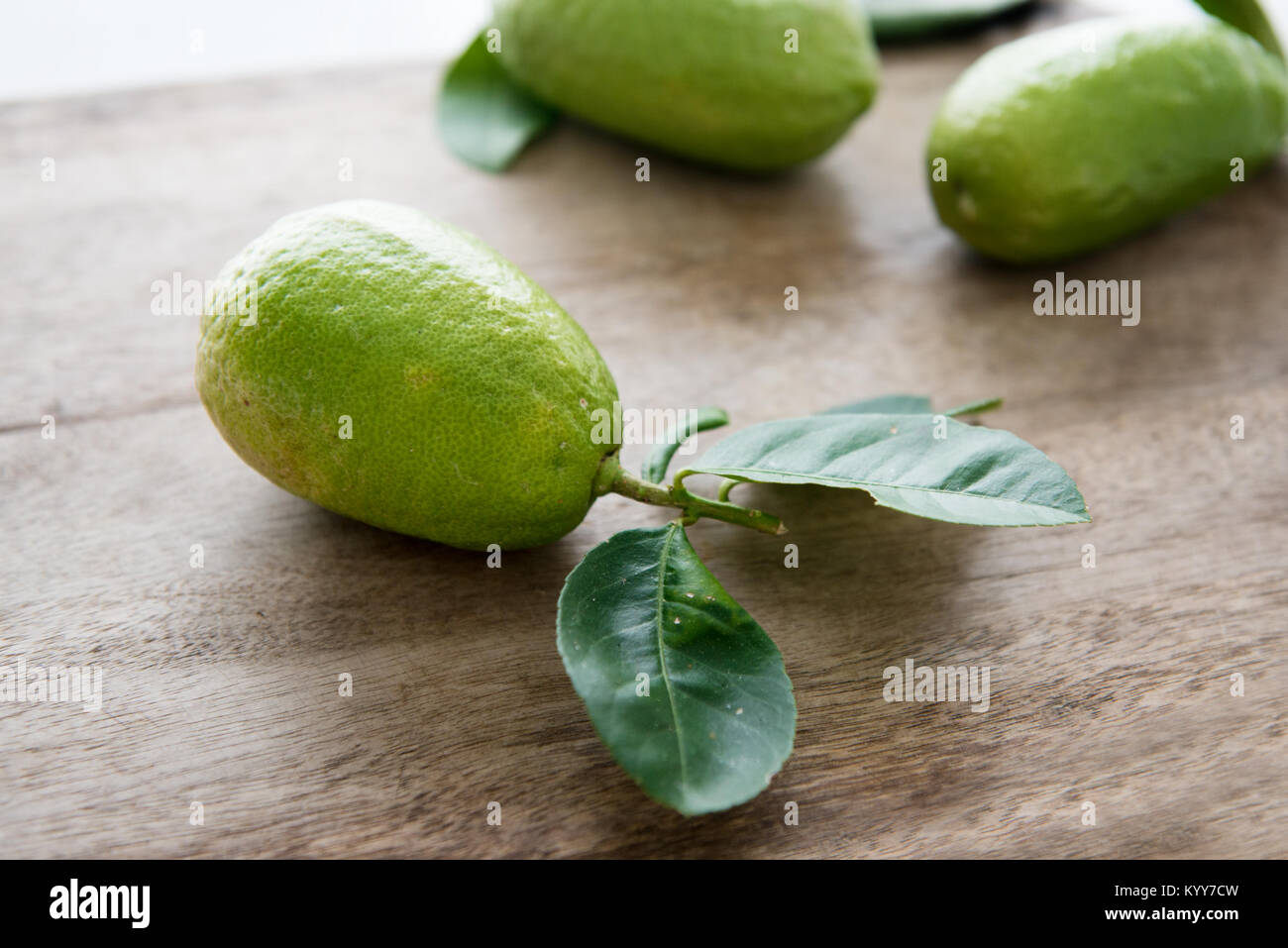 Fresh organic lemons with leaves on wood background, pesticide free ...