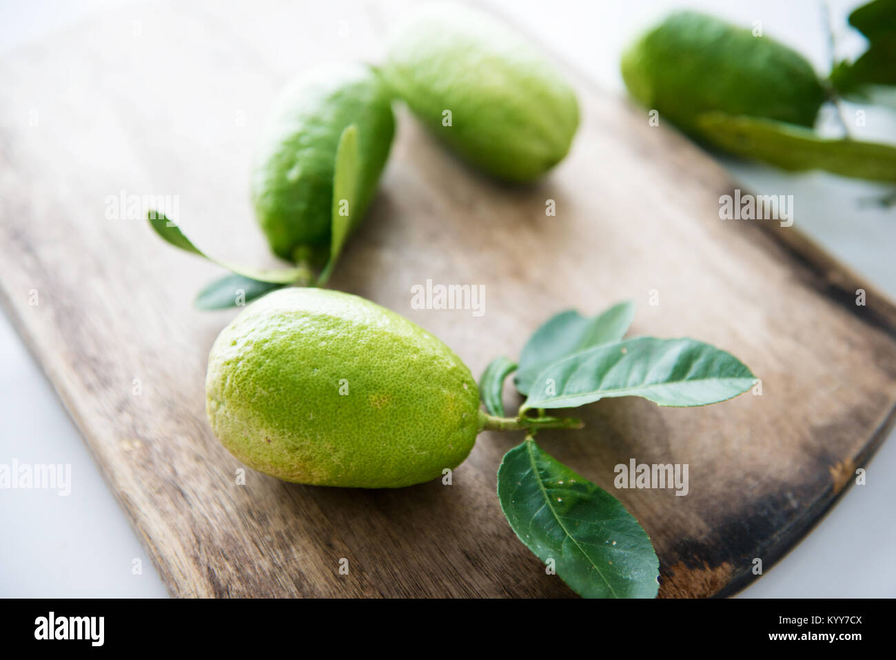 Fresh organic lemons with leaves on wood background, pesticide free ...