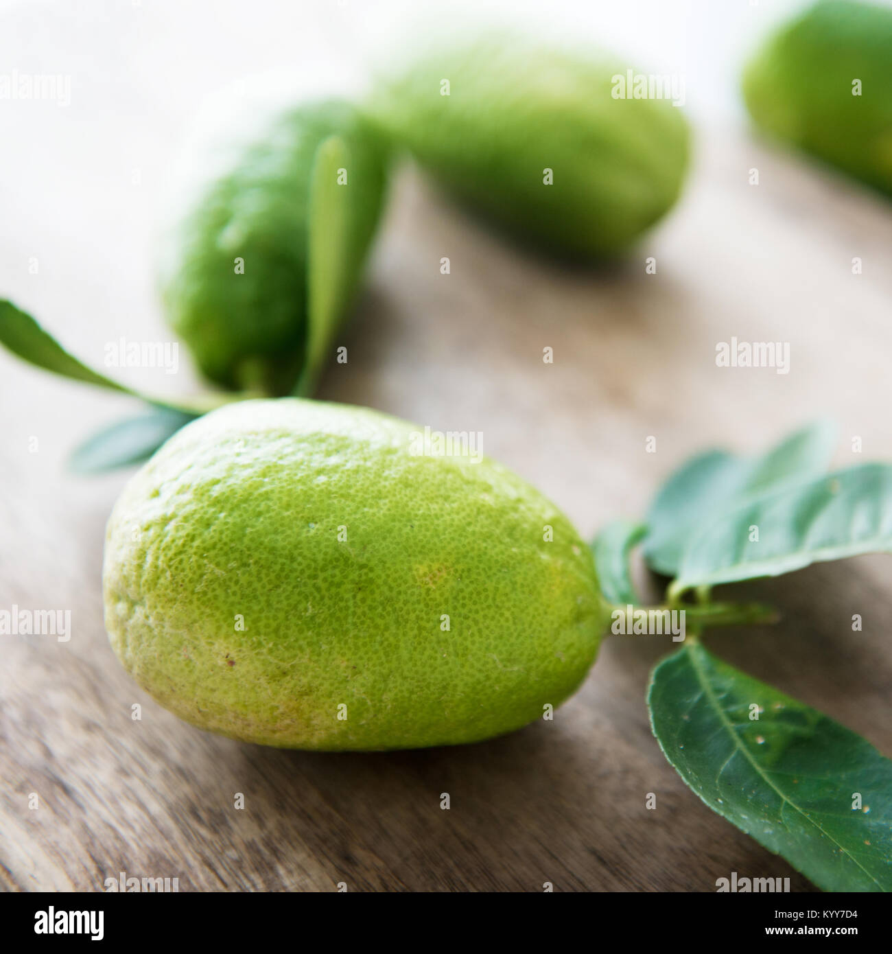 Pesticide free fresh organic lemons with leaves on wood background ...