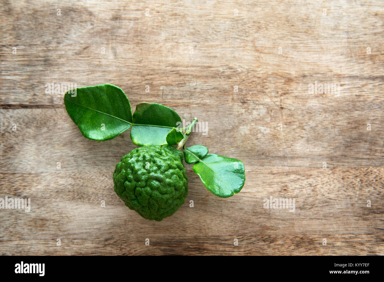 Pesticide free fresh organic kaffir lime with leaves on wooden ...