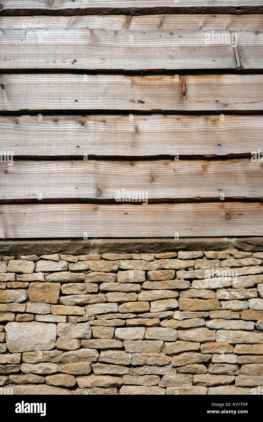 Feather edge timber cladding above a drystone wall Stock Photo - Alamy