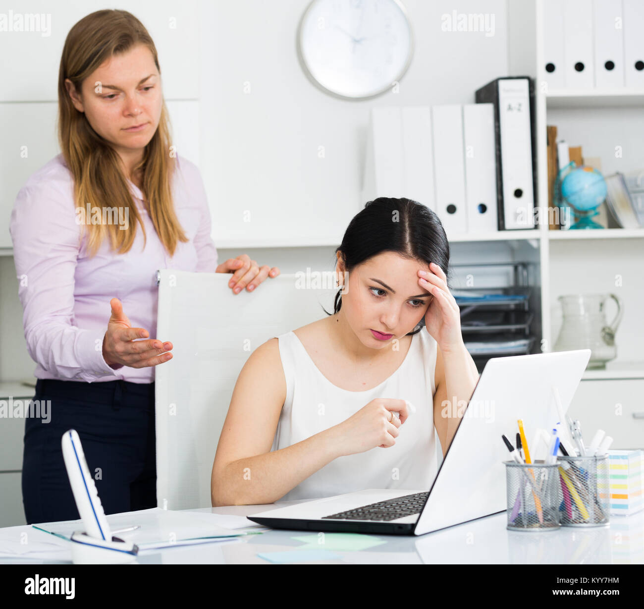 Female senior manager telling off her co-worker during working day ...