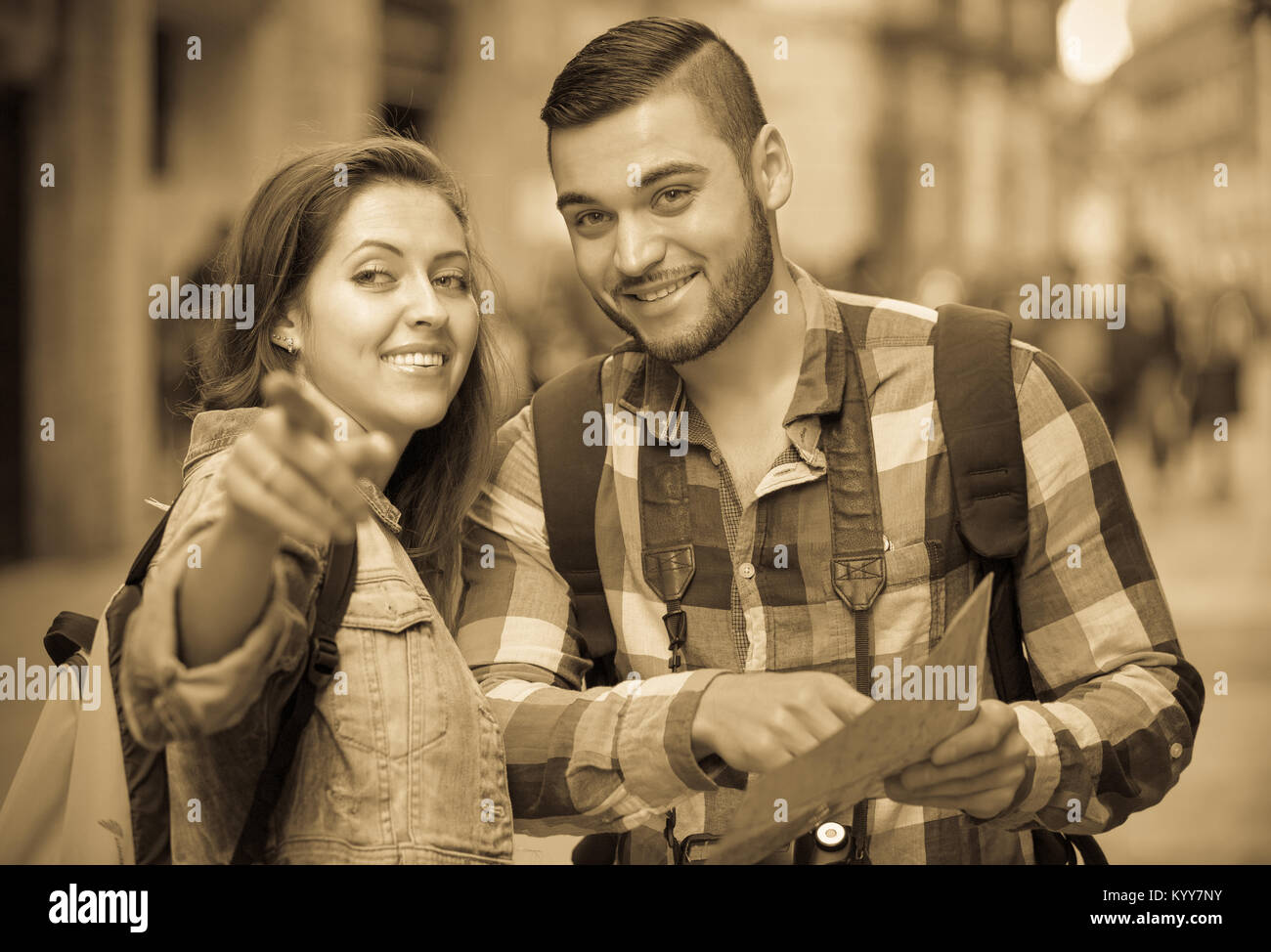 Happy young girl points the direction at the city Stock Photo - Alamy