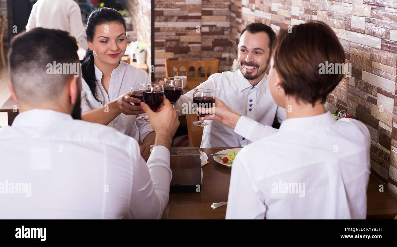 Group of friends eating dinner in rustic restaurant Stock Photo - Alamy