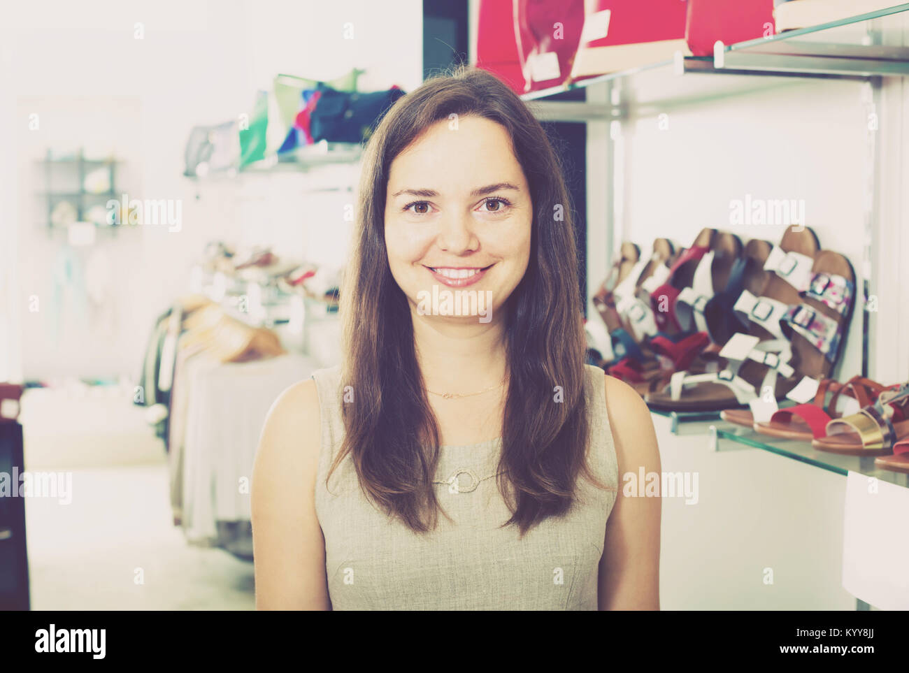 Footwear shop smiling girl posing with different shoes Stock Photo - Alamy
