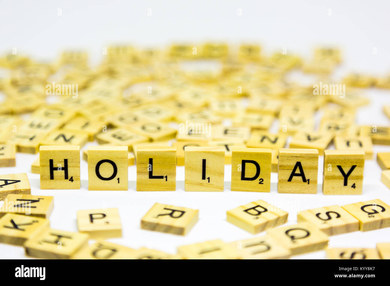 The word holiday standing up made from wooden scrabble letters on a ...