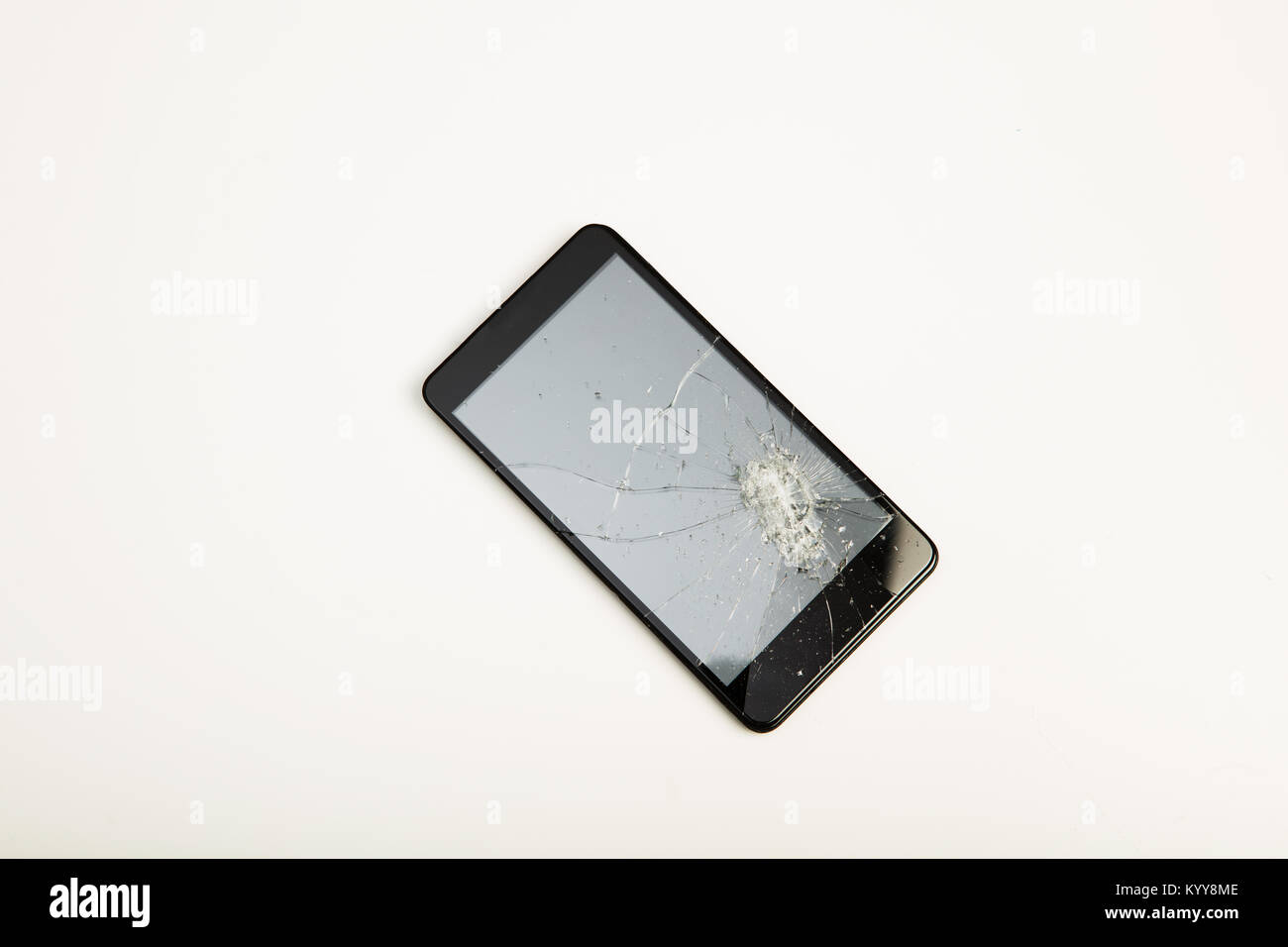 Studio shot high-angle view close-up of a black damaged smartphone with ...