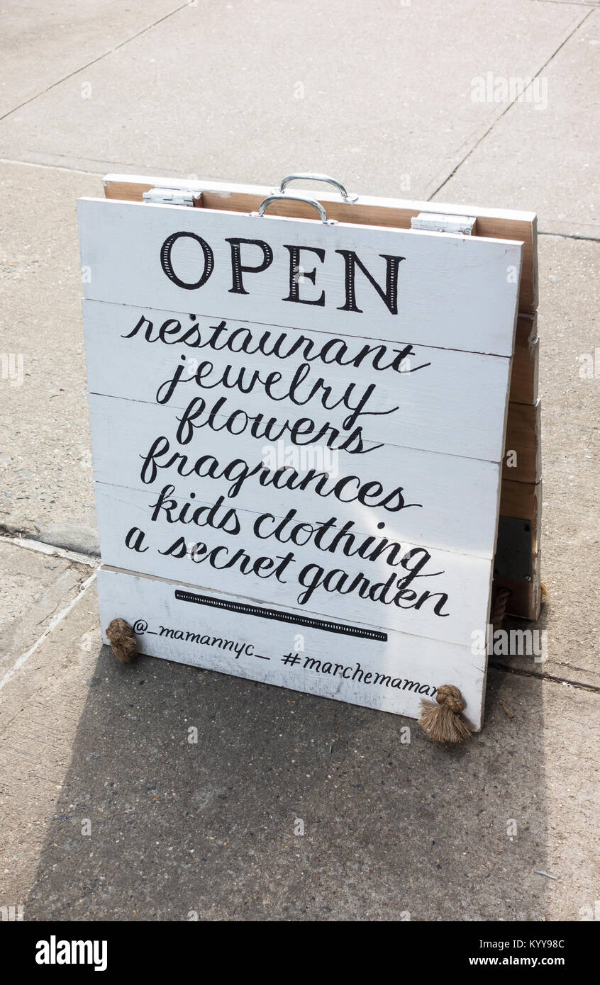Folding street sign announcing the opening of a new restaurant and ...