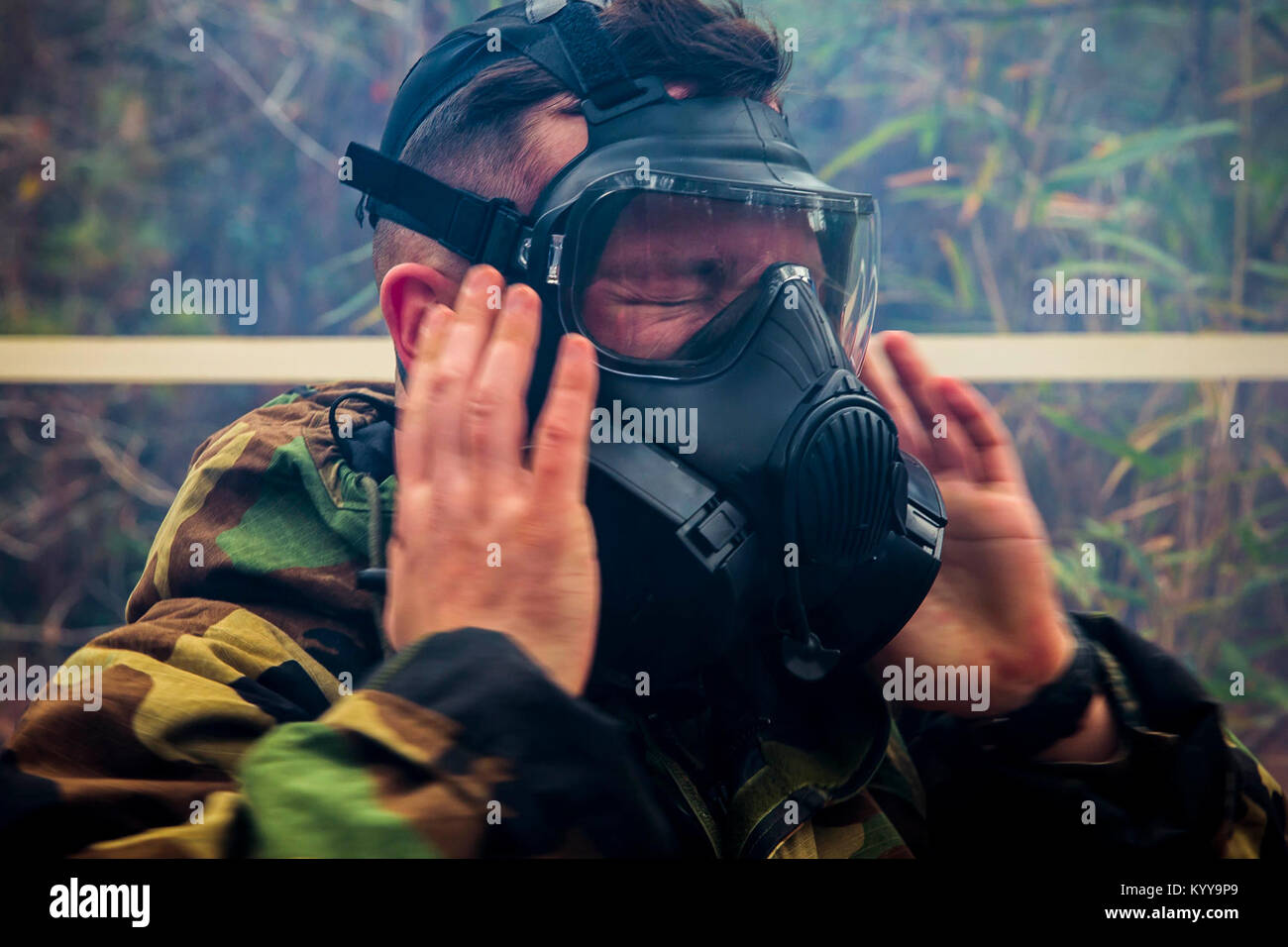 A U.S. Marine with the 26th Marine Expeditionary Unit equips his gas ...