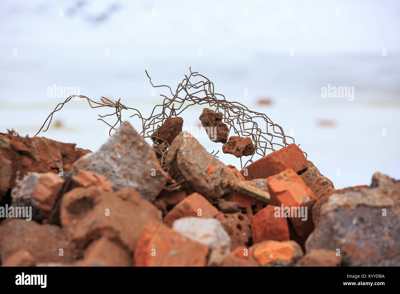A pile of construction debris with broken bricks and concrete in winter ...