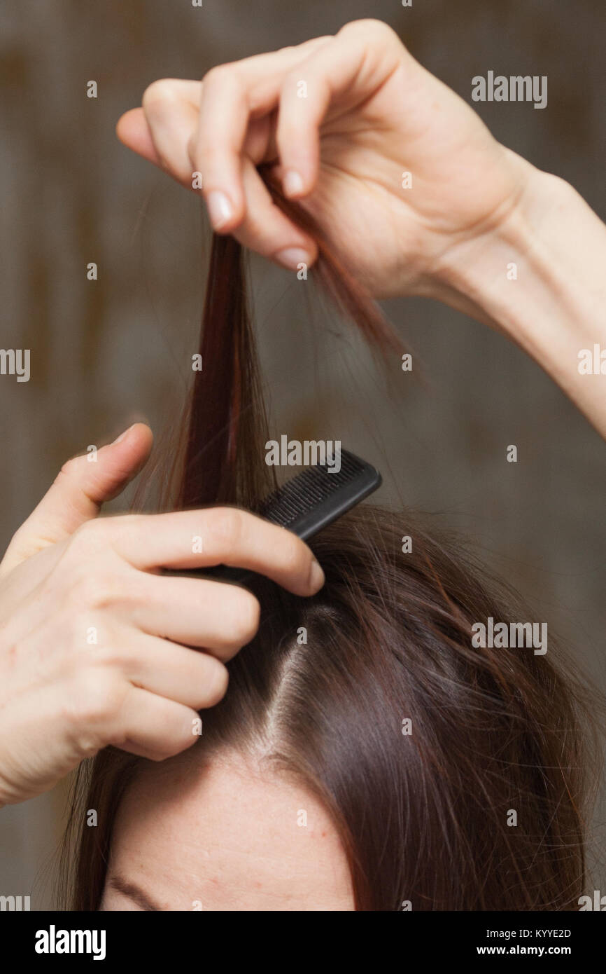The process of combing a plastic comb, close-up Stock Photo - Alamy