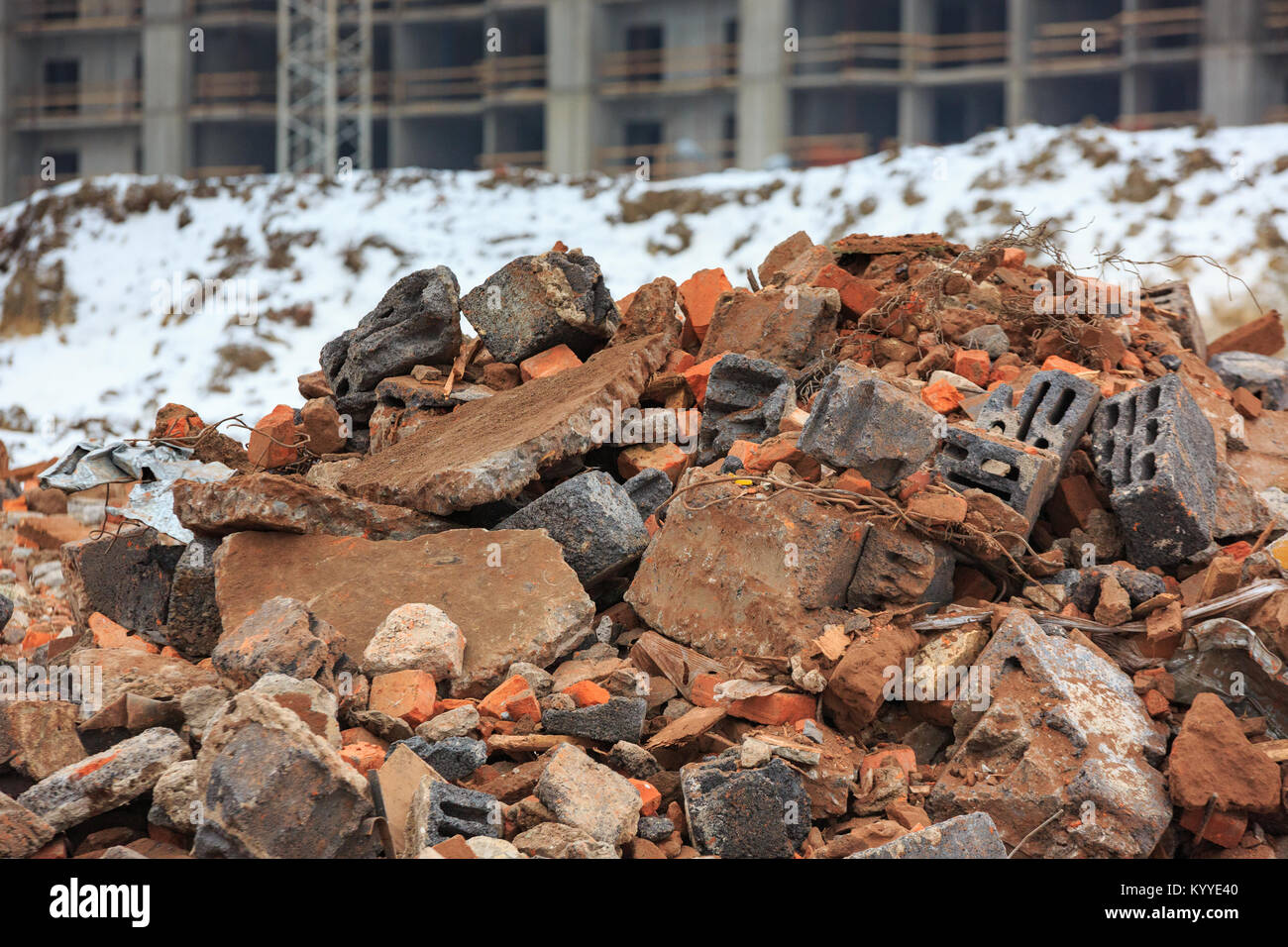 A pile of construction debris with broken bricks and concrete in winter ...