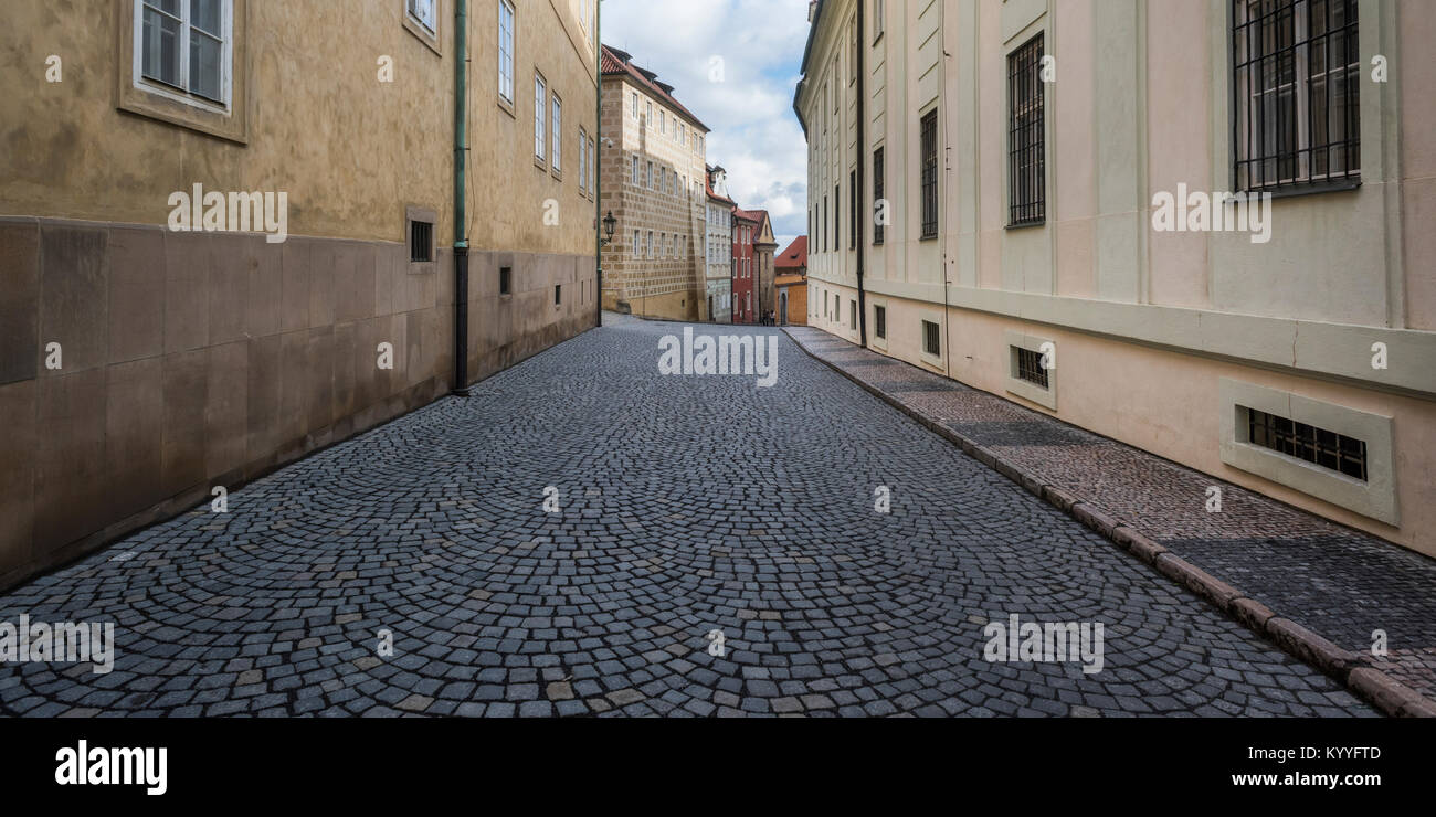 Buildings along narrow cobblestone alleyway Prague, Czech Republic ...