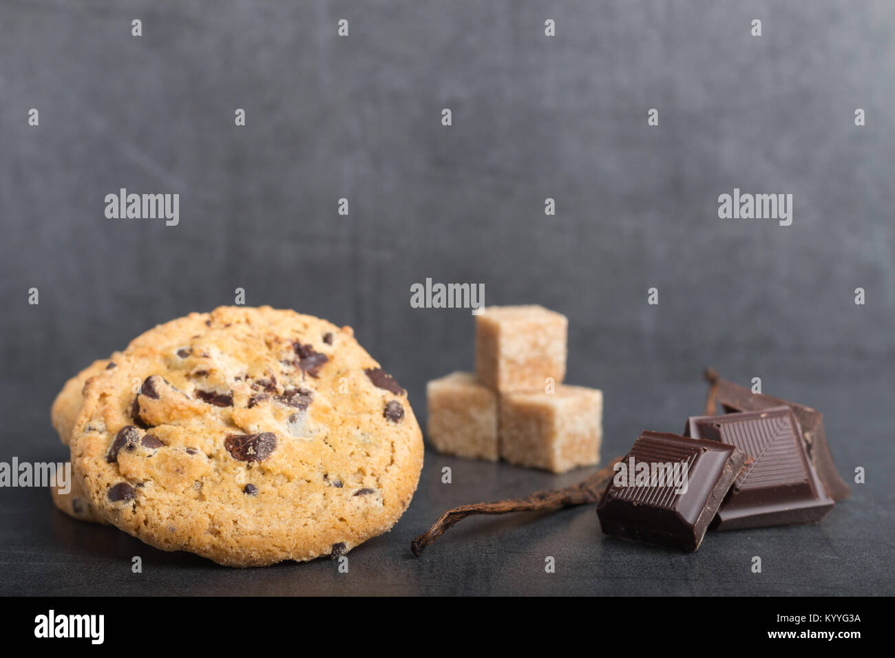 chocolate chip cookies with ingredients on a kitchen table Stock Photo ...