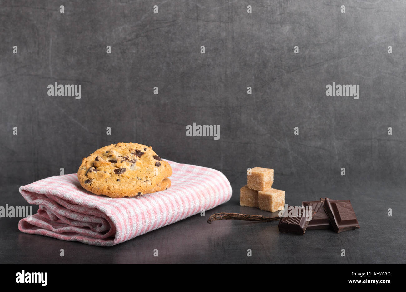 chocolate chip cookies with ingredients on a kitchen table Stock Photo ...