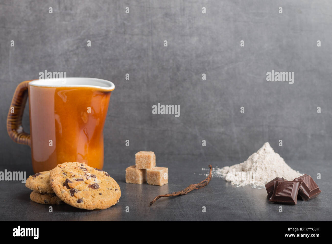 chocolate chip cookies with ingredients on a kitchen table Stock Photo ...
