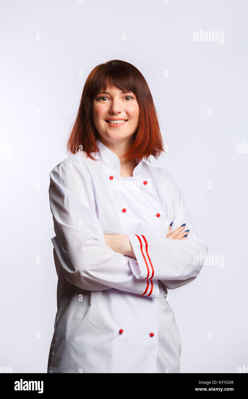 Image of female chef in white robe with arms crossed at waist on empty ...