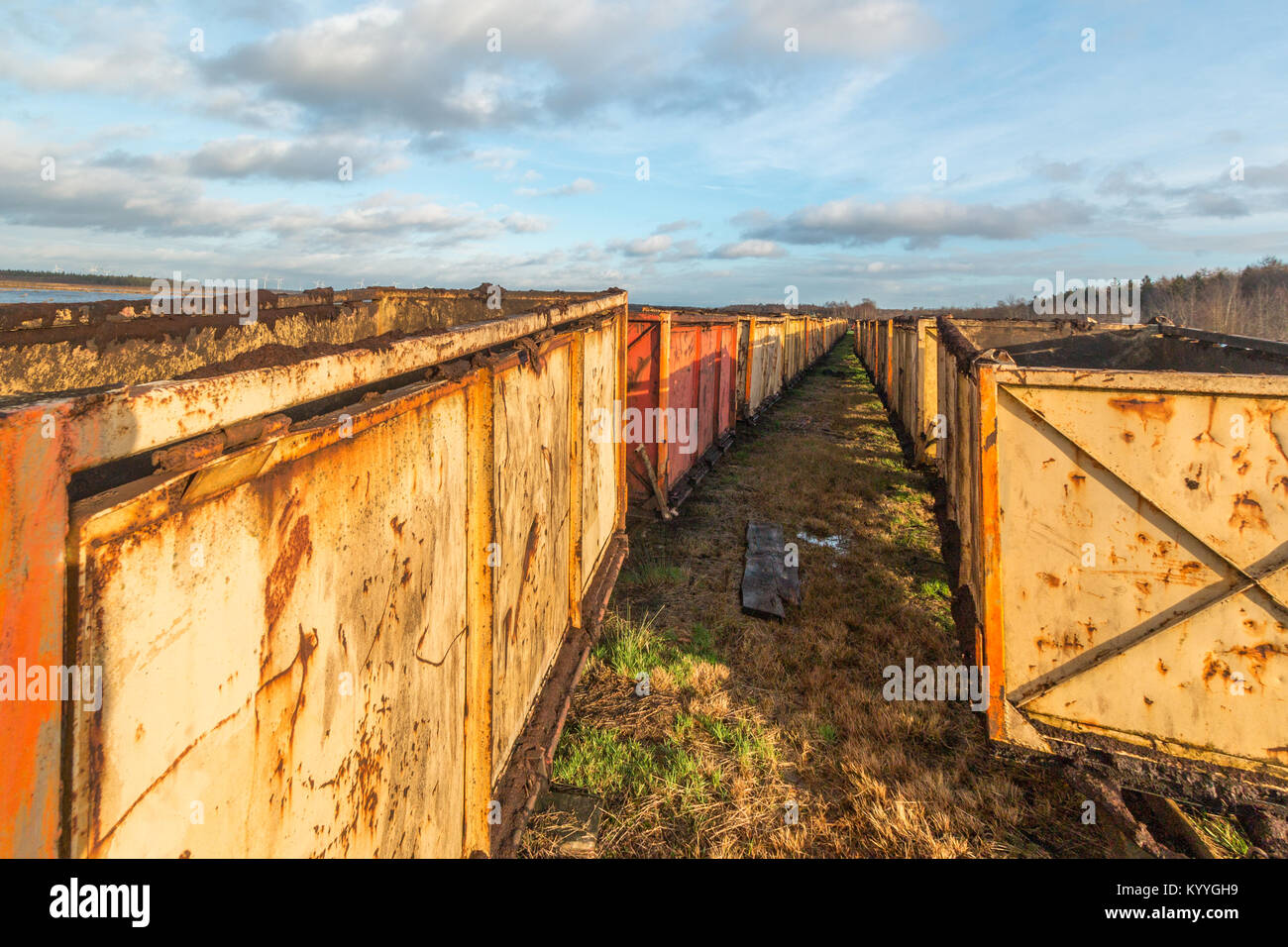 A train of empty old carts for peat mining Stock Photo - Alamy