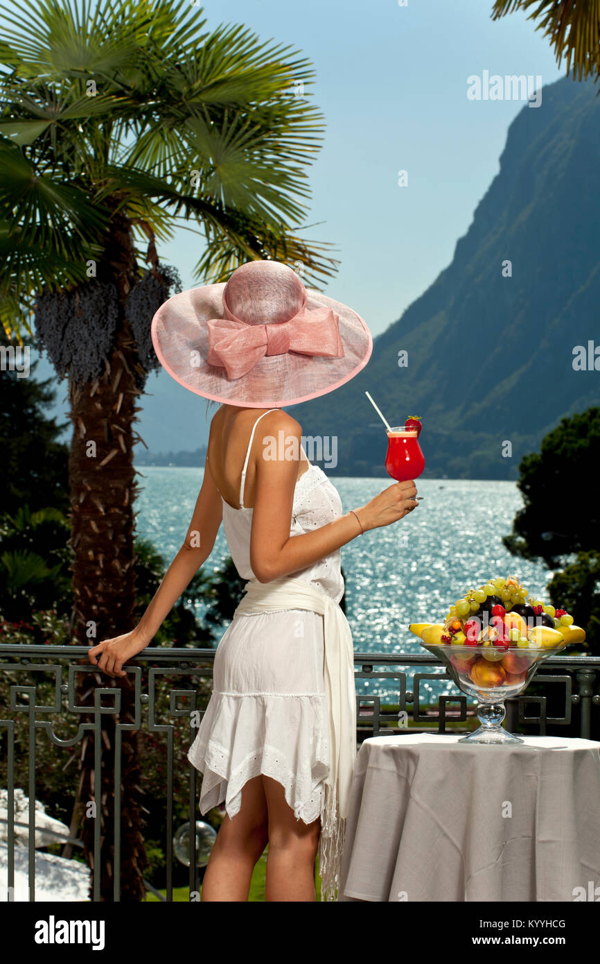 portrait of beautiful woman on the terrace of prestigious hotel back ...