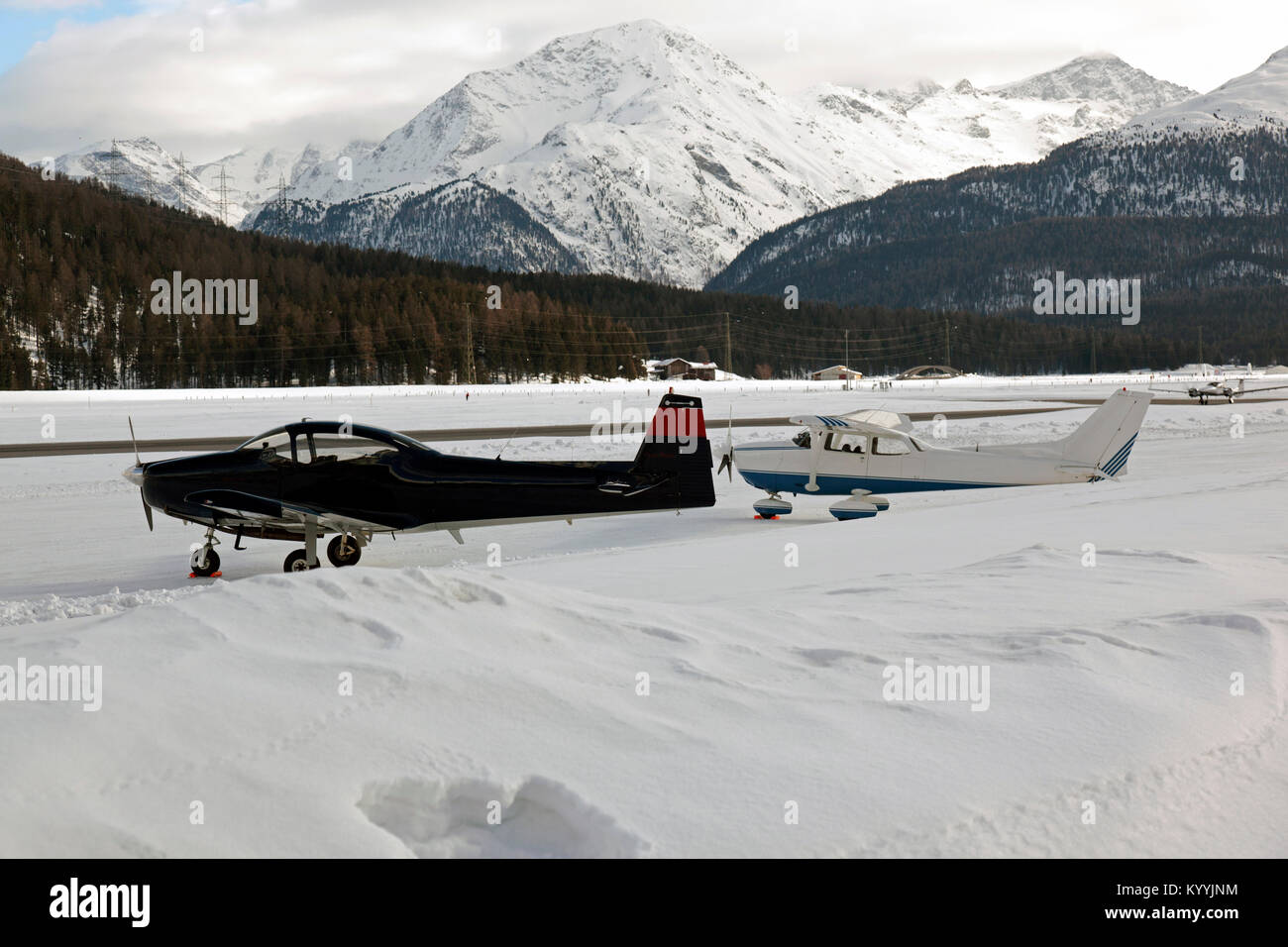 Private planes, jets and propellers in the snow covered landscape in ...