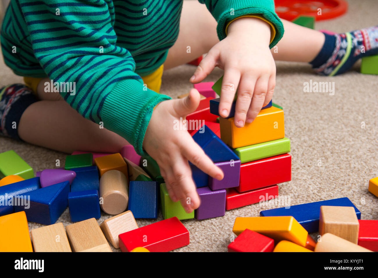Child playing with building blocks learning new skills, educational ...