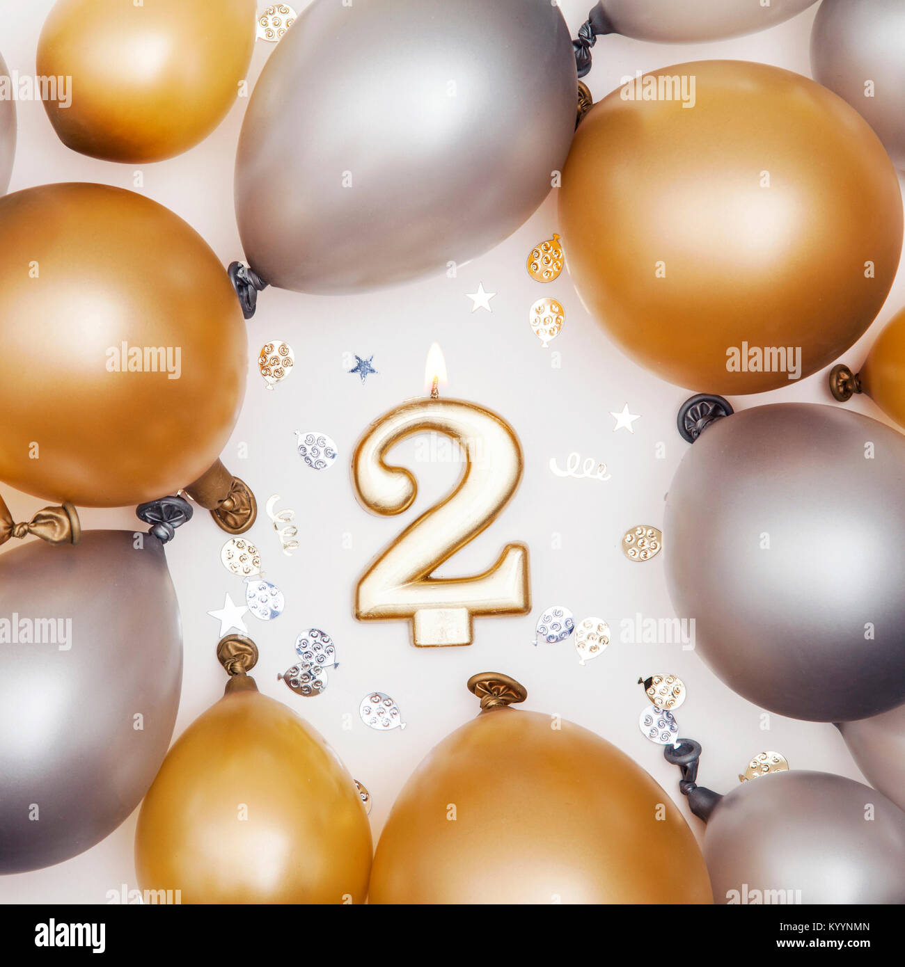 Birthday celebration number 2 candle with gold and silver balloons ...