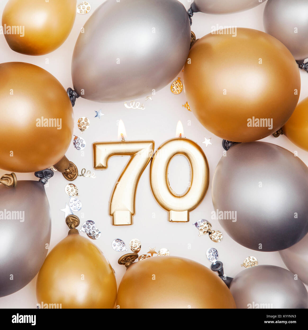 Birthday celebration number 70 candle with gold and silver balloons ...