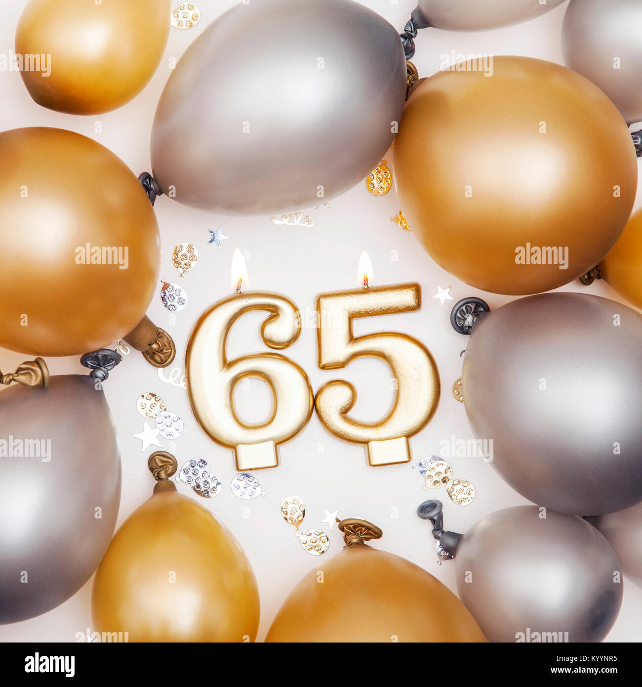 Birthday celebration number 65 candle with gold and silver balloons ...