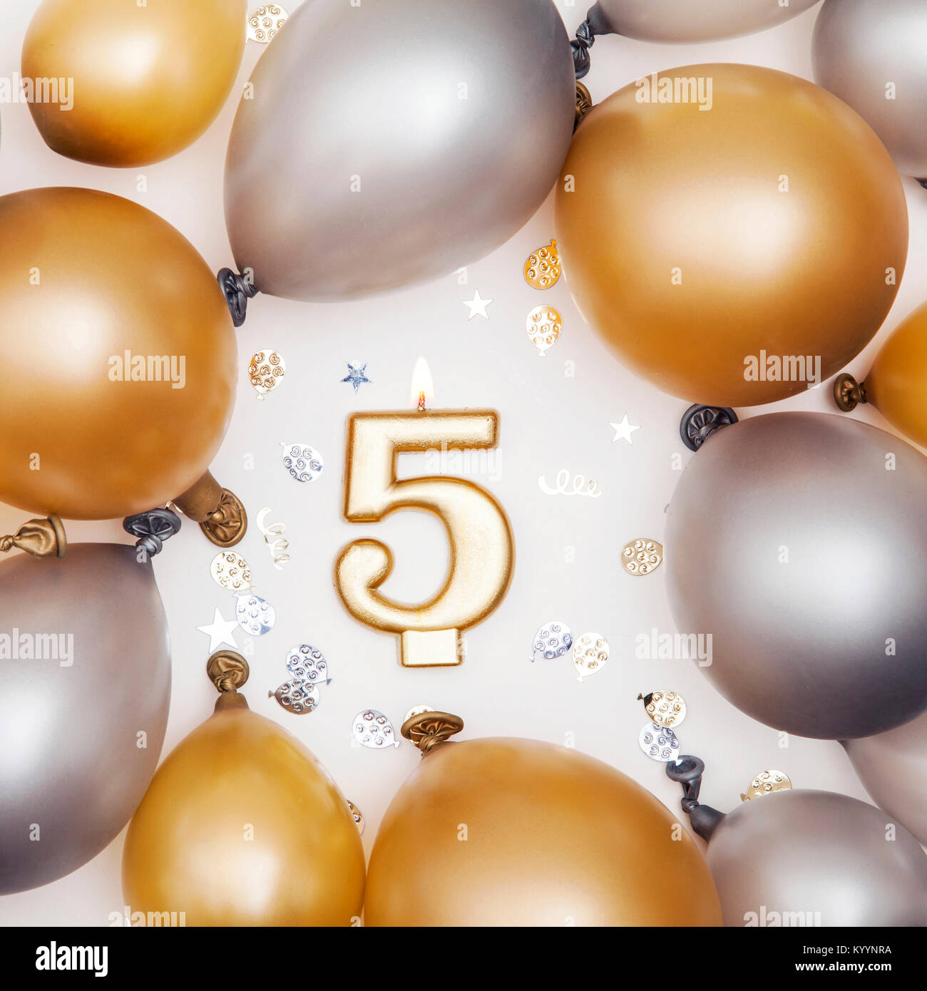 Birthday celebration number 5 candle with gold and silver balloons ...