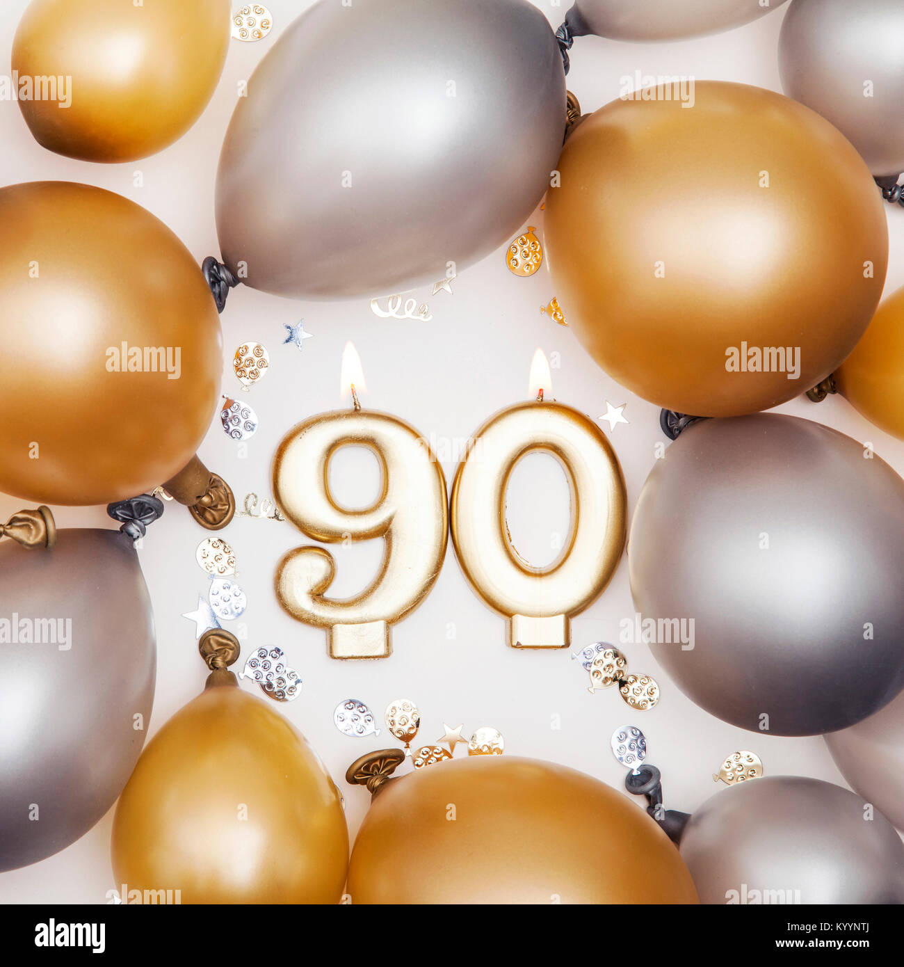 Birthday celebration number 90 candle with gold and silver balloons ...