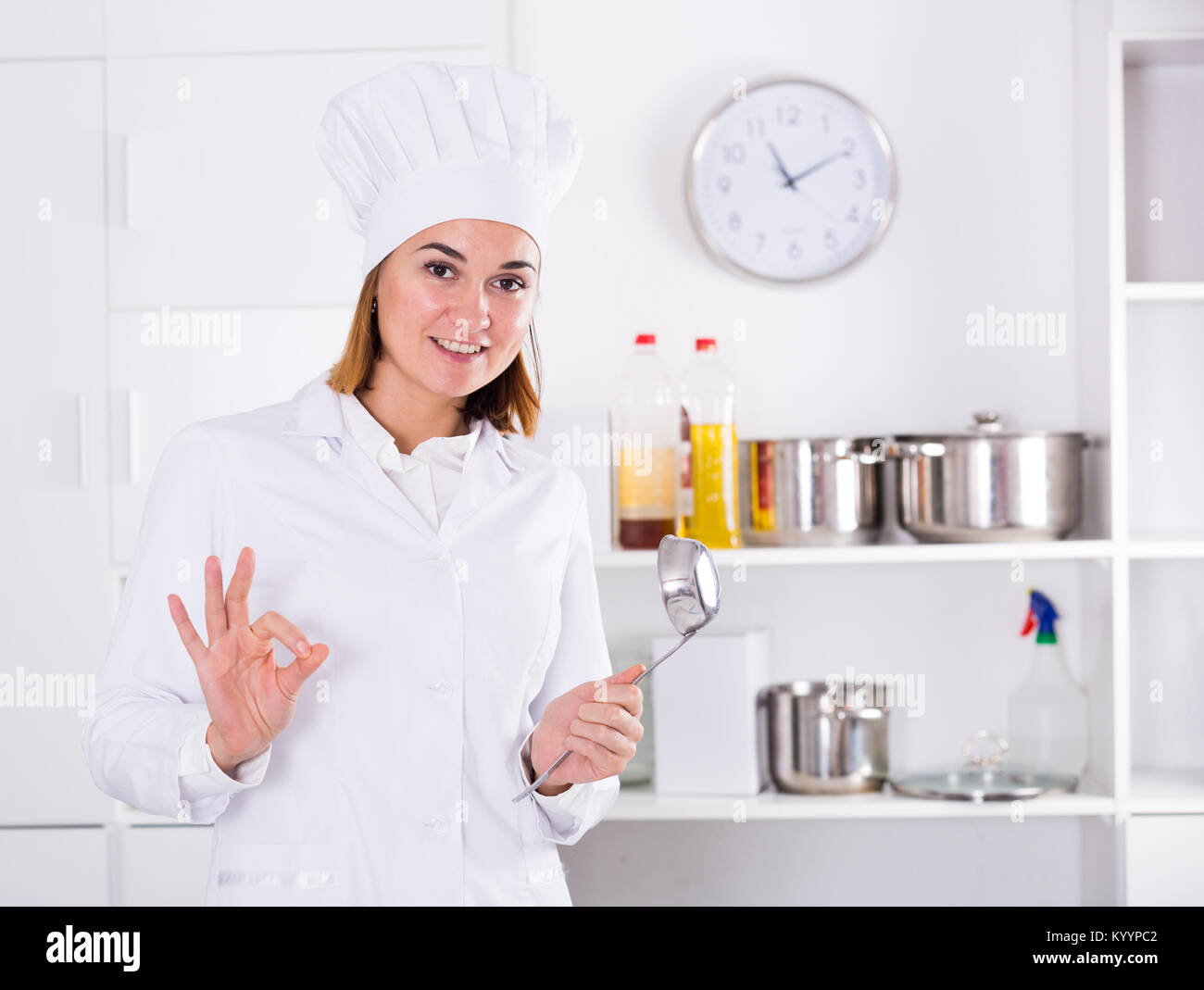 Smiling woman cook making tasty dishes in kitchen Stock Photo - Alamy