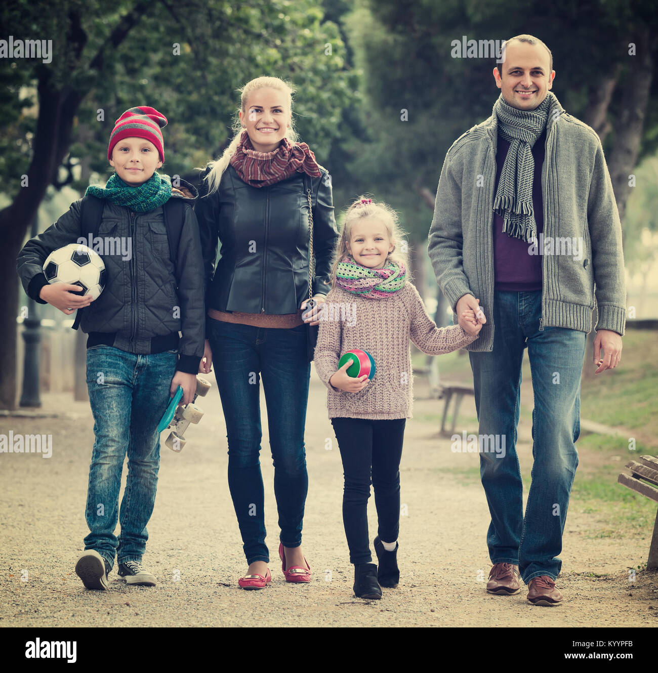 positive spanish spouses with children posing in autumn park and ...