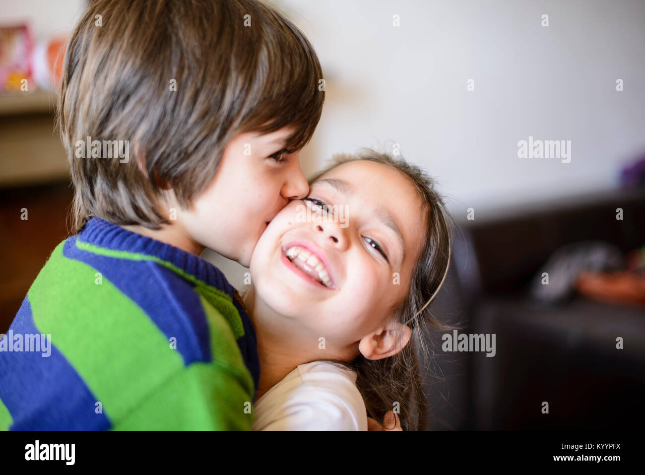 children brothers kiss on the cheek laughing and playing at home Stock ...