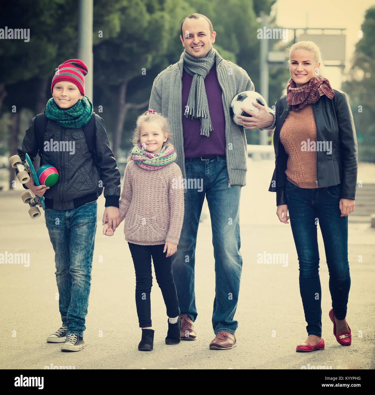 Portrait of happy smiling parents with school age children posing ...