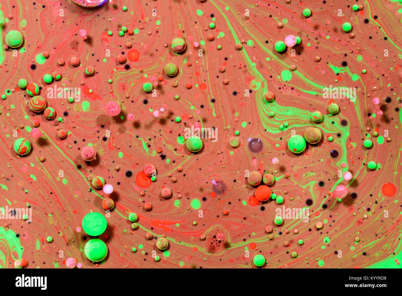 Toxic chemical acrylic oil droplets on water creating the idea of ...