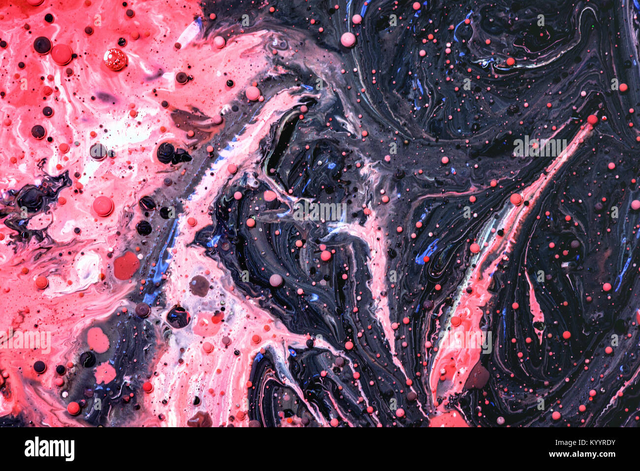 Toxic chemical acrylic oil droplets on water creating the idea of ...