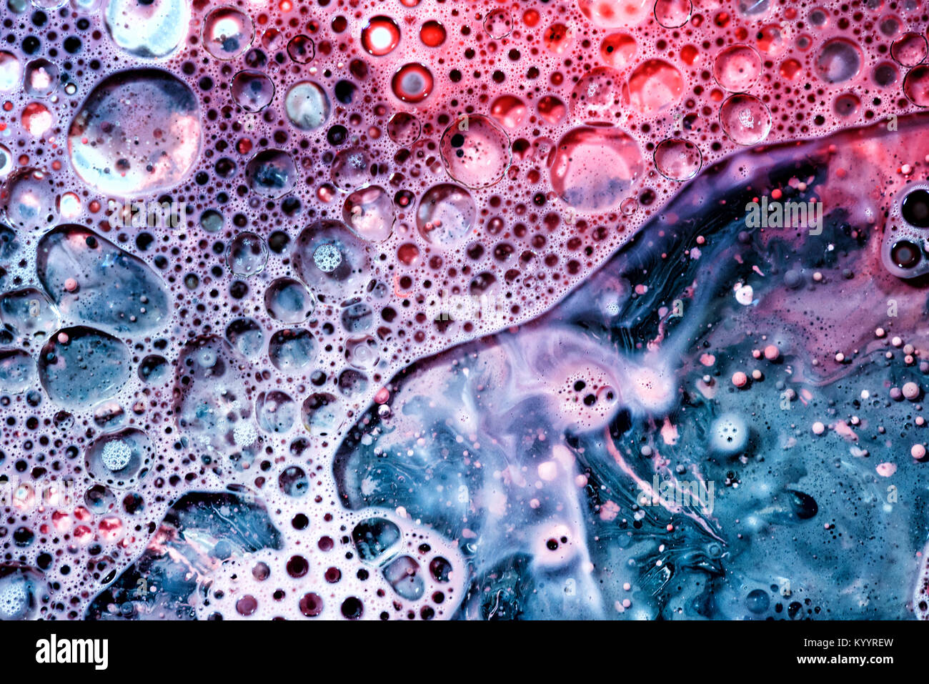 Toxic chemical acrylic oil droplets on water creating the idea of ...