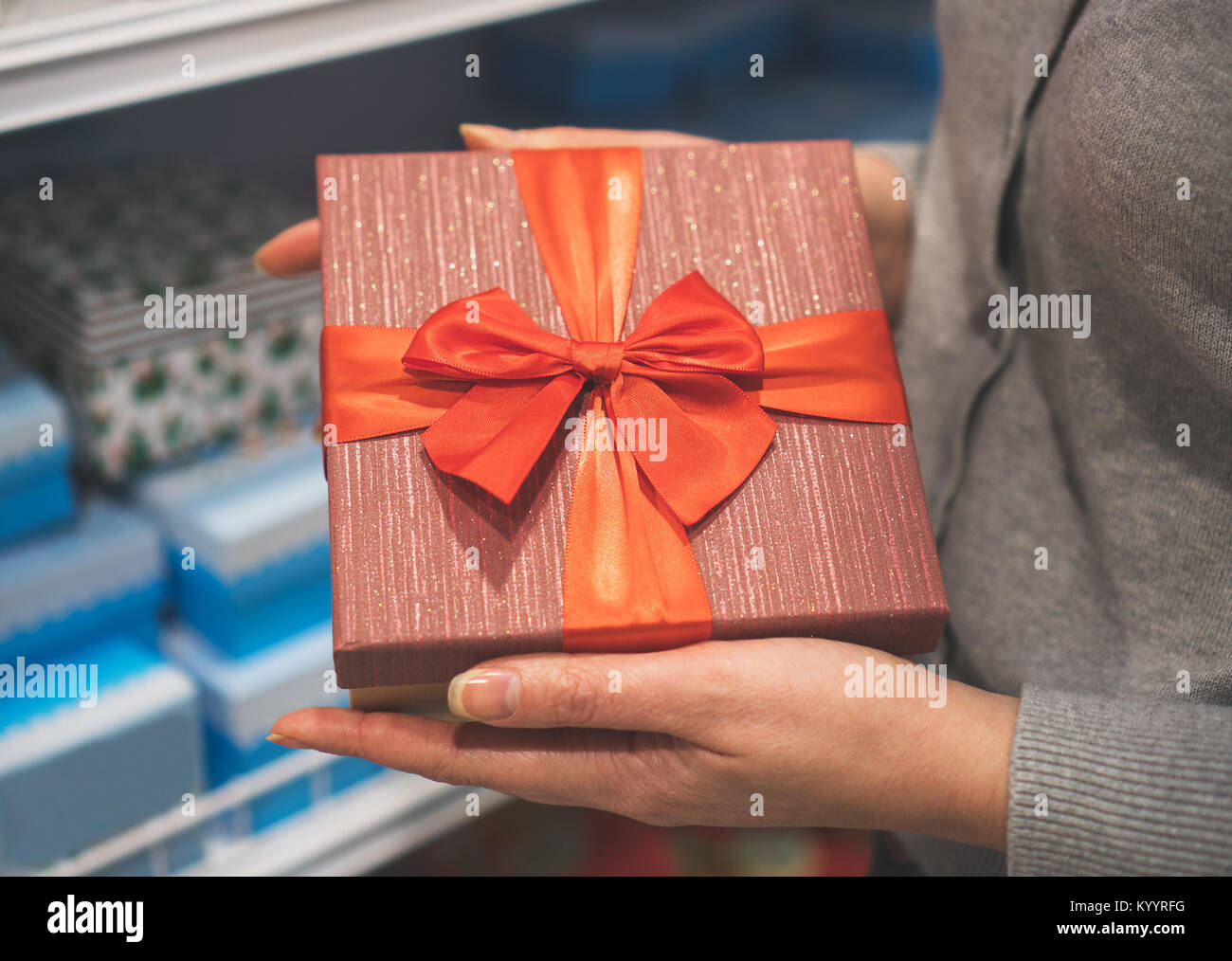 Close-up of female hands holding gift box Stock Photo - Alamy