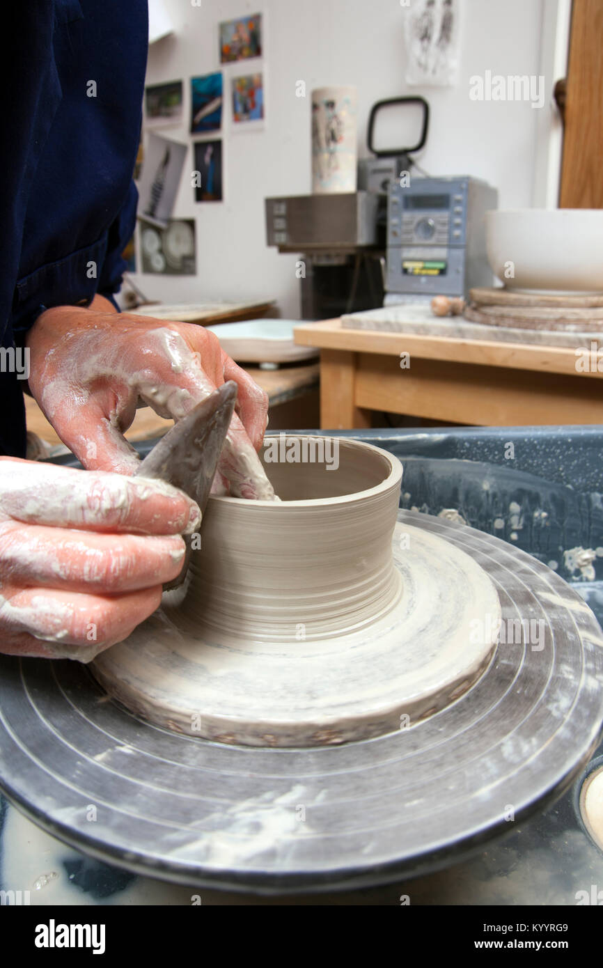 A lady ceramics artist at work in her home pottery studio Stock Photo ...