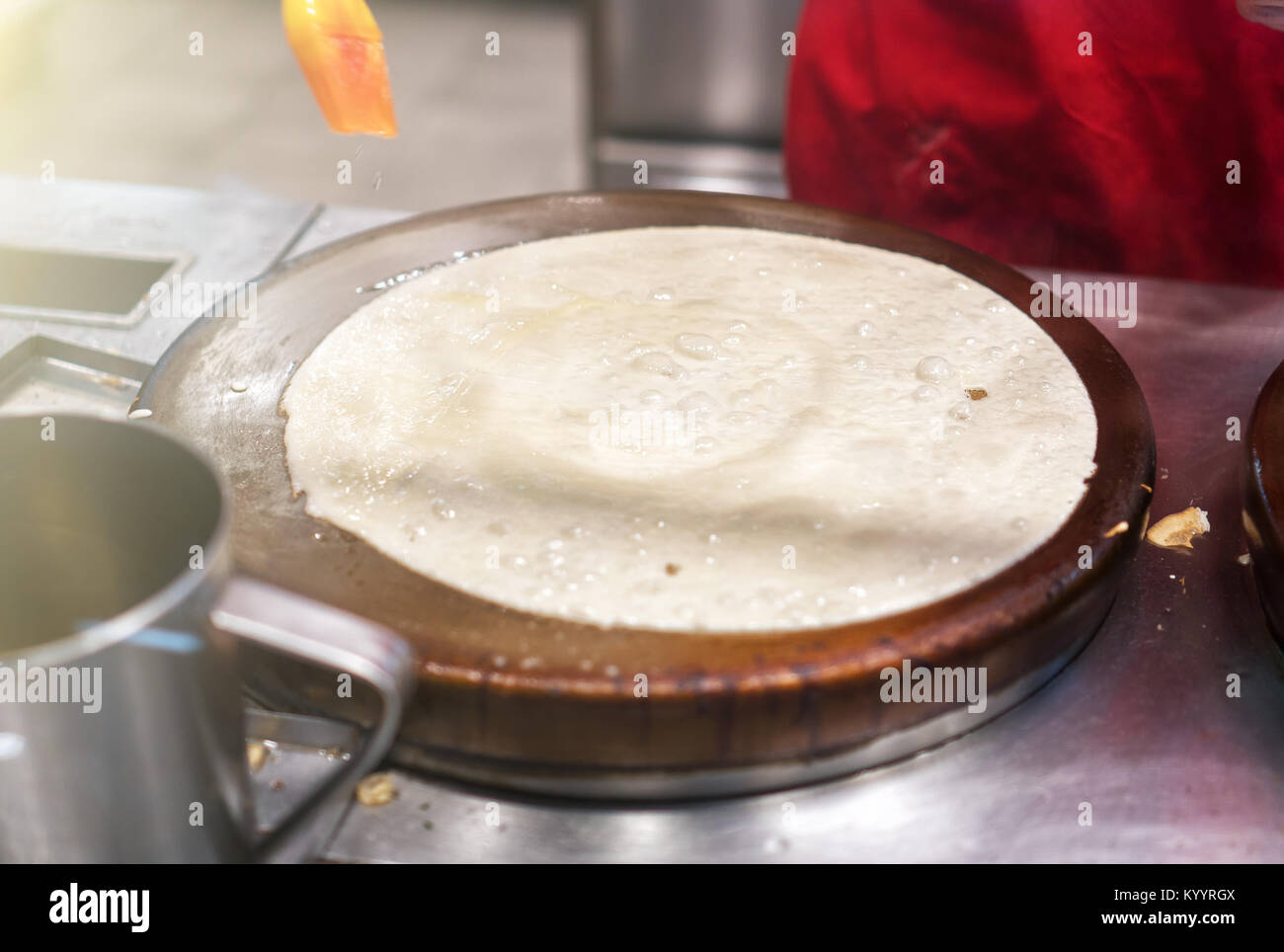 Preparation of pancake. Cook works in the kitchen Stock Photo - Alamy
